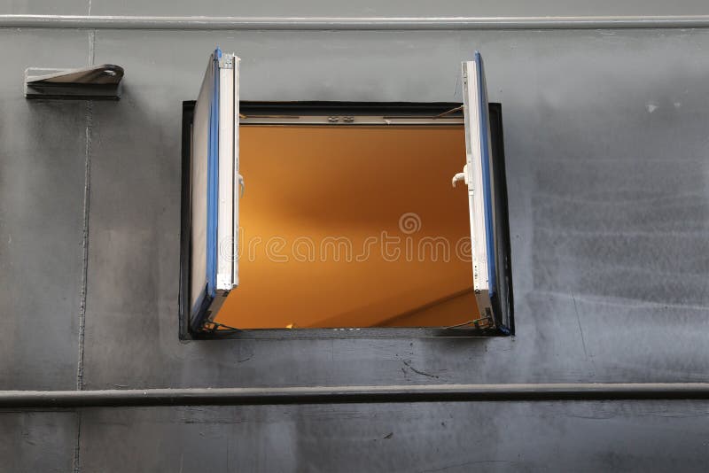 An Open Window in a Steel Wall with Orange Glow Inside. Stock Photo ...