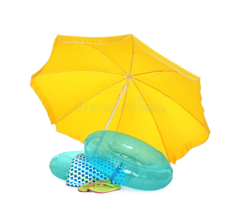 Open Yellow Beach Umbrella, Inflatable Rings, Blanket and Flip Flops on ...