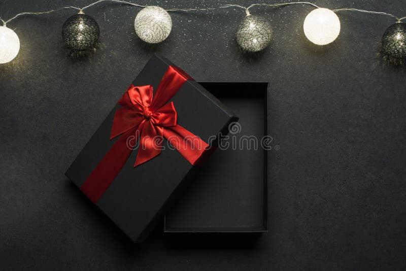 Opened Black Gift Box with Red Ribbon. Gift on a Black Granite Surface ...