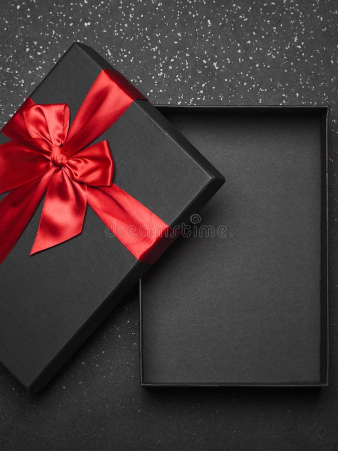Opened Black Gift Box with a Red Ribbon and a Large Bow on a Dark ...