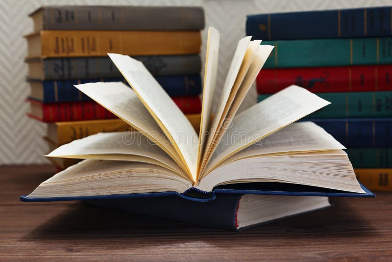 Opened Book in Front of Stack of Books Stock Photo - Image of opening ...