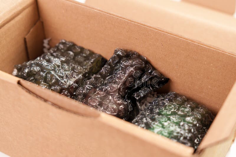 Opened Cardboard Gift Parcel Box with Bubble Wrapped Items Stock Photo ...