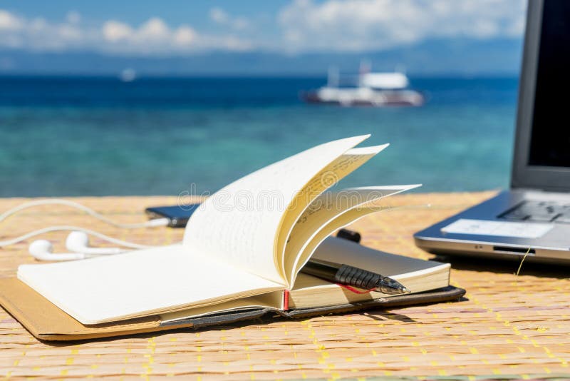 Opened Empty Notepad is on the Table with Phone and Headphones at the ...