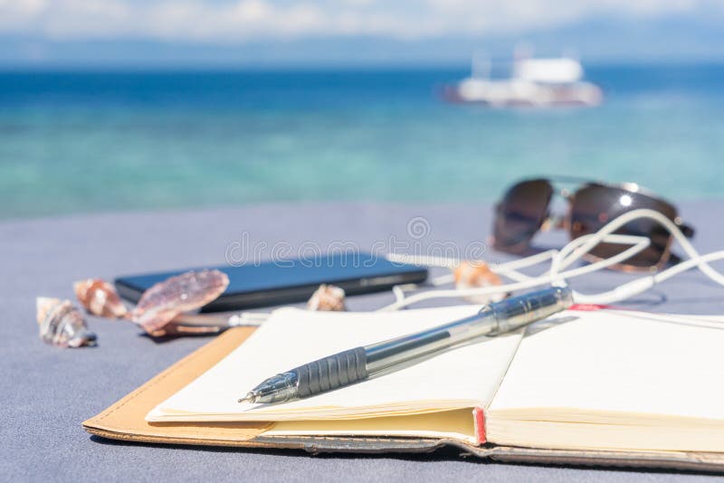 Opened Empty Notepad is on the Table with Phone and Headphones at the ...