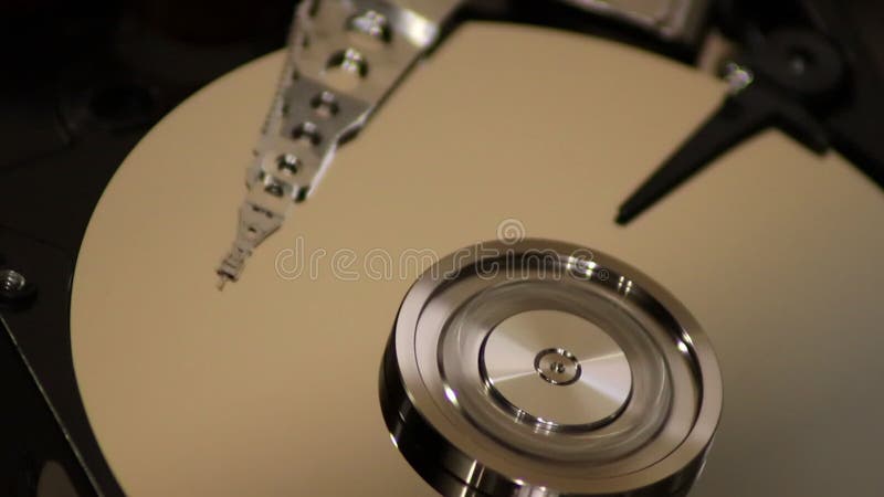 Opened Hard Disk Drive with Spinning Platter. Move of Writing Magnetic ...