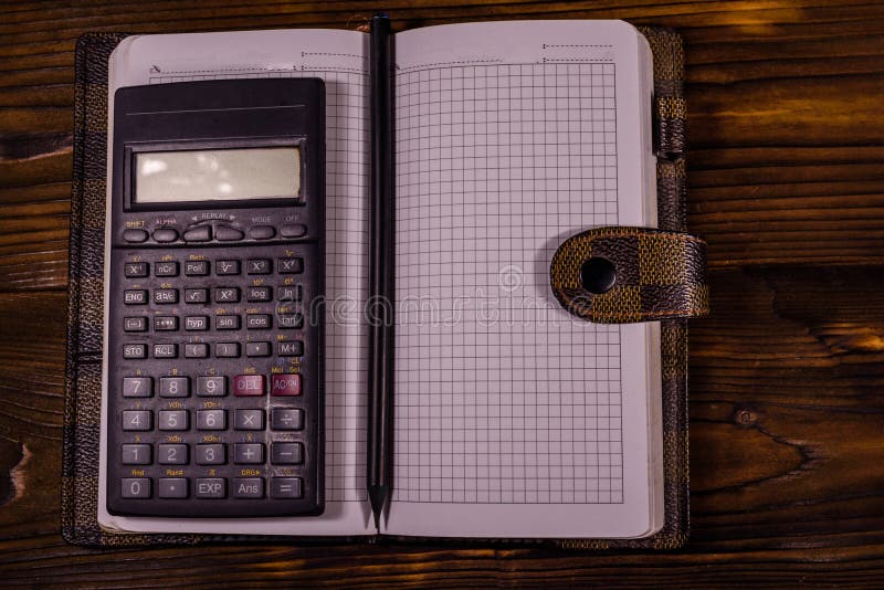 Opened Notepad, Scientific Calculator and Pencil on Wooden Table. Top ...