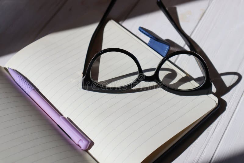 Opened Notepad and Spectacles on the Table. Stock Photo - Image of ...