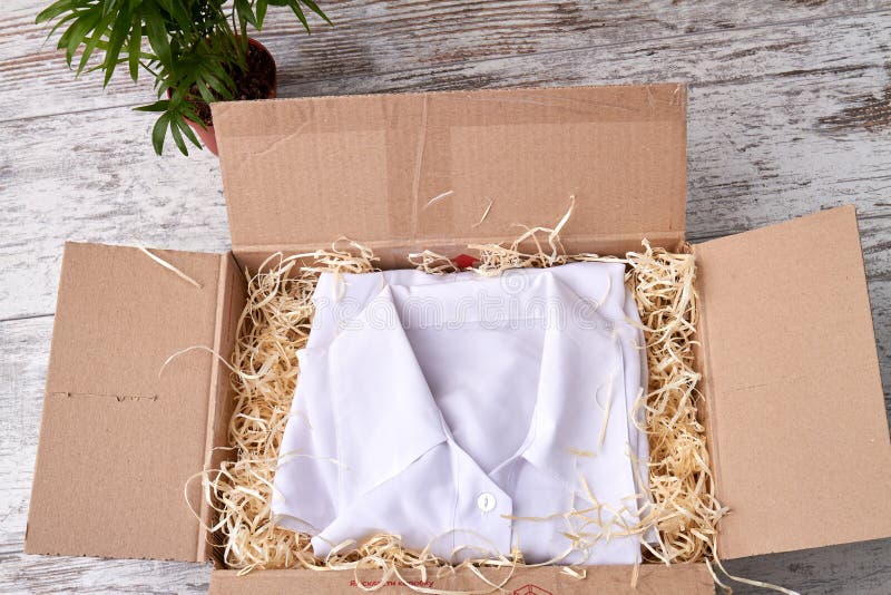 Opened Parcel with White Shirt. Stock Photo - Image of cardboard ...