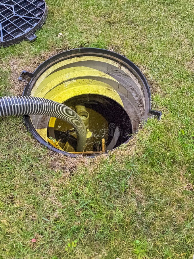 Opened the Sewer Hatch and Inserted a Hose for Cleaning the Septic Tank ...