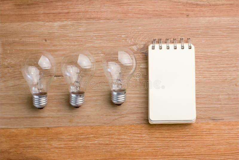 Opened Spiral Notebook with Light Bulb Stock Photo - Image of light ...