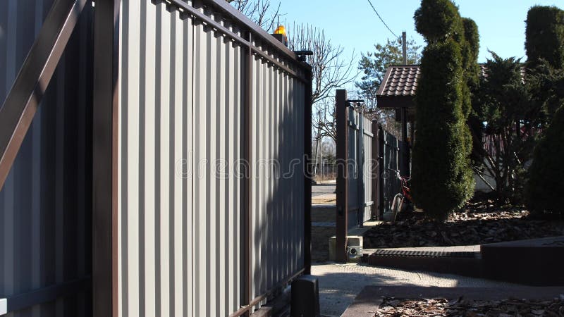Opening Automatic Metal Gates on a Remote Control in a Private House ...