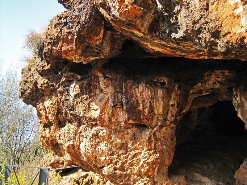 Opening of a Cave in the Side of a Rocky Hill Stock Image - Image of ...