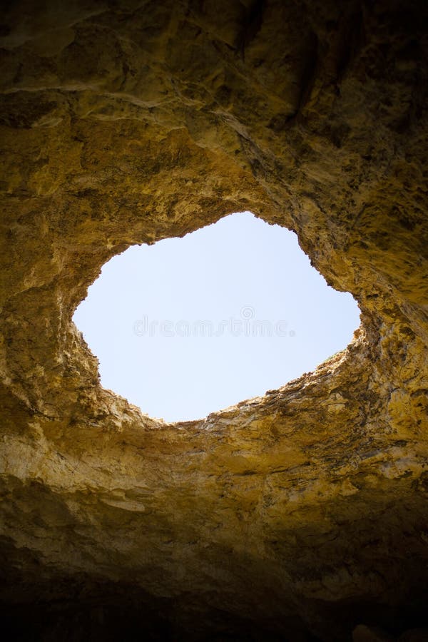 Cave opening onto a beach stock image. Image of rocks - 62738267