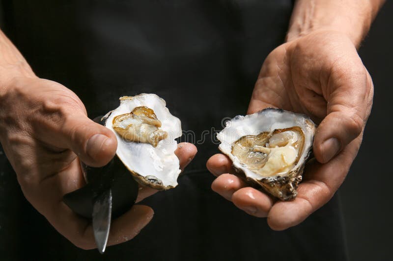 Man Opening Shell of Fresh Oyster on Dark Background Stock Photo ...