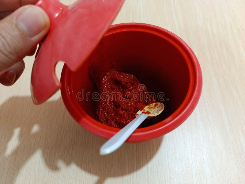 Opening Red Container with Paste and Spoon on Table Stock Photo - Image ...