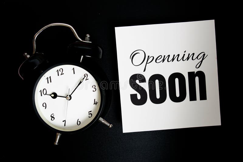 Opening Soon Text on Paper Card with Alarm Clock Top View on Black ...