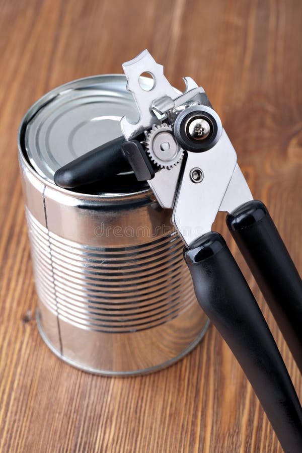 Tin opener opening a can stock image. Image of opener - 34330359