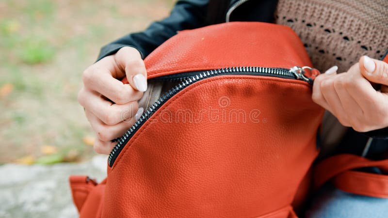 Opening the Zip of a Red Backpack Stock Photo - Image of zipper, person ...