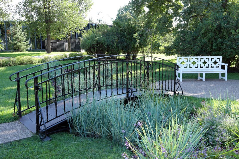 An Openwork Bridge Over a Dry Stream and a Bench for Relaxing in the ...