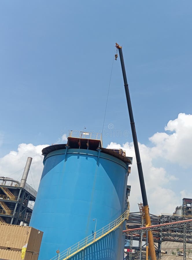 Operating a Crane Above a Water Tank at a Project Site Stock Image ...