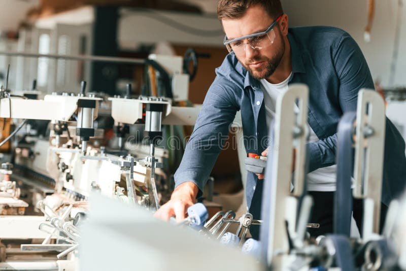 Operating the Machine. Handsome Man is Working at the Factory of ...