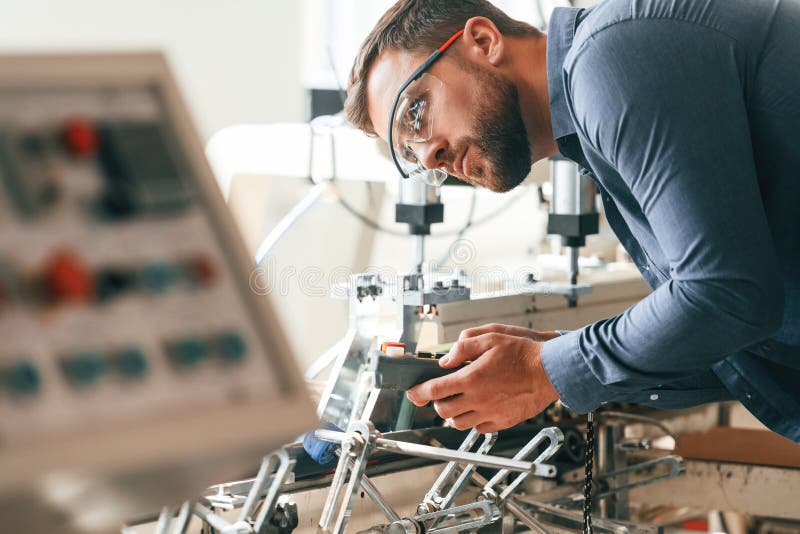 Operating the Machine. Handsome Man is Working at the Factory of ...