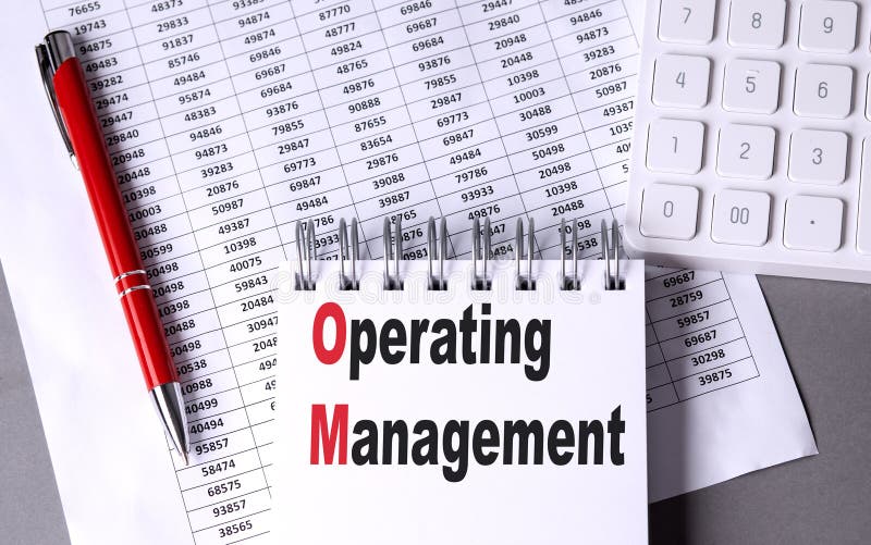 OPERATING MANAGEMENT Text on Notebook with Chart , Pen and Calculator ...