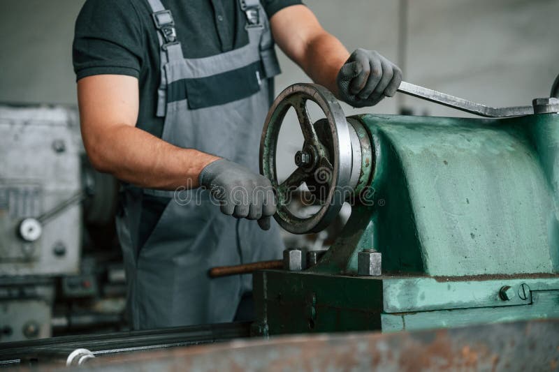 Operating Manufacturing Equipment. Man in Uniform is in Workstation ...