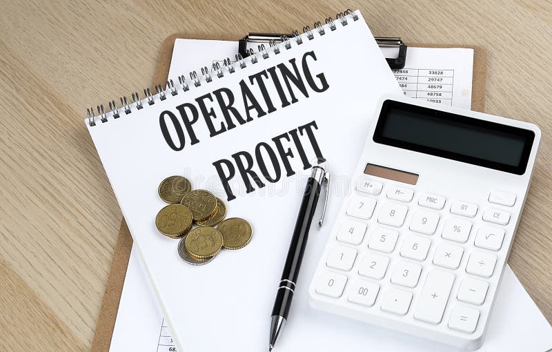 OPERATING PROFIT Text on a Notebook with Chart and Calculator and Coins ...