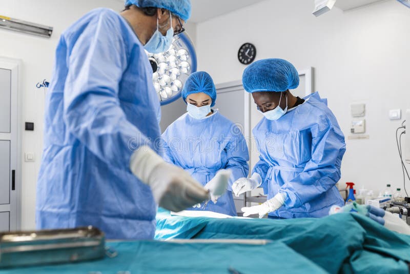 Operating Room of Surgical Table with Instruments, Assistant Picks Up ...