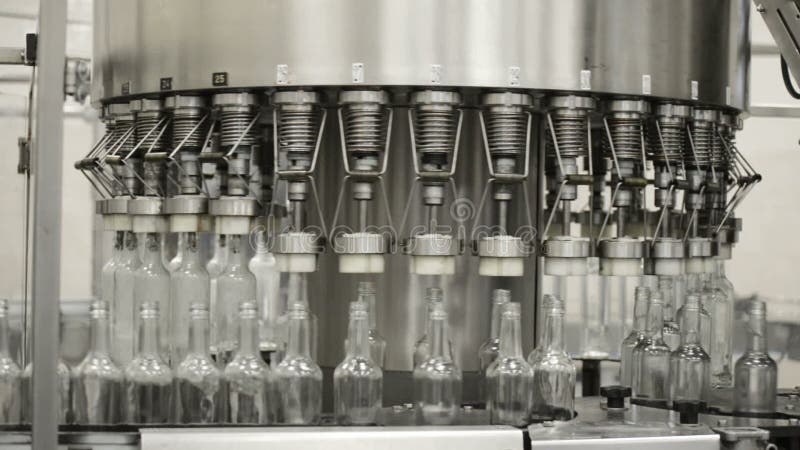 Automatic Bottle Rinsing, Filling and Capping Machine. Automation of ...