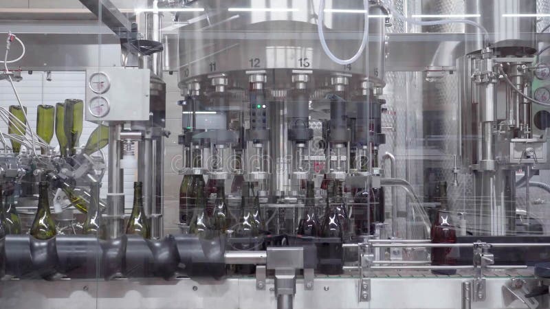 The Operation of the Conveyor for Bottling Wine with Overturning Green ...