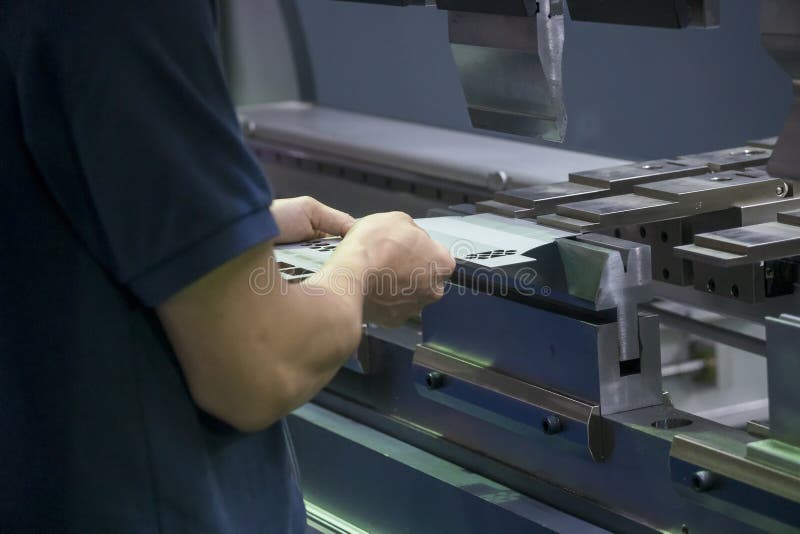 The Operation of Hydraulic Bending Machine with Technician. Stock Photo ...