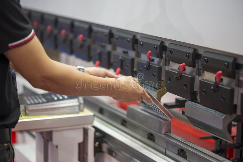 The Operation of Hydraulic Bending Machine with Technician. Stock Photo ...
