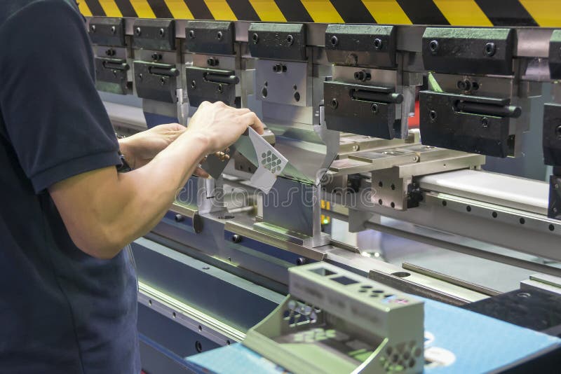 The Operation of Hydraulic Bending Machine with Technician. Stock Photo ...