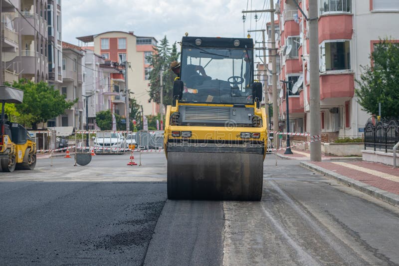 Paver Machine on a New Asphalt Road Surface. Laying of a New Asphalt ...
