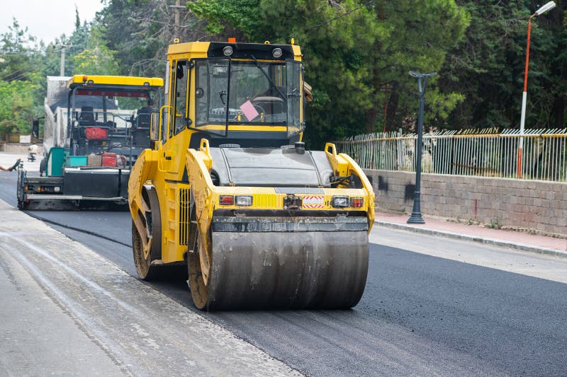 Paver Machine on a New Asphalt Road Surface. Laying of a New Asphalt ...