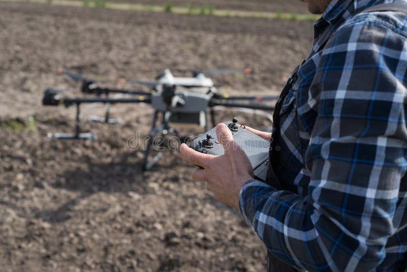 The Operator of the Agricultural Drone Controls the Remote Control, the ...