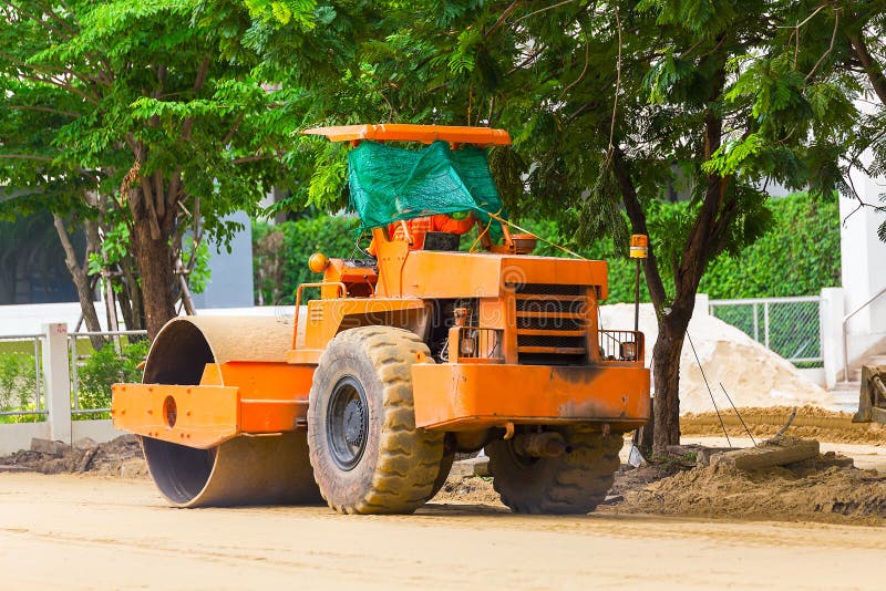 An Operator Backs a Steamroller Over Dirt To Prepare for a Construction ...