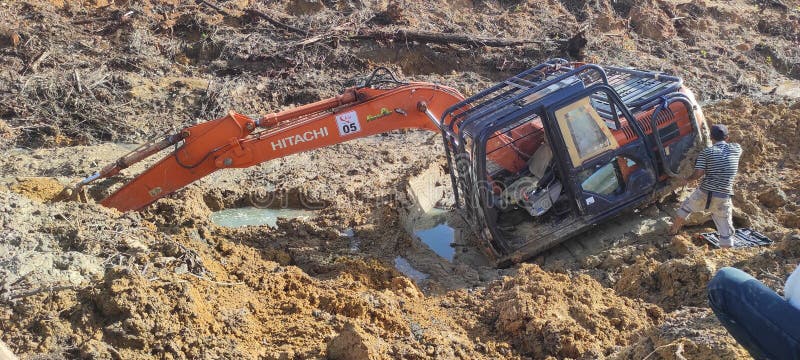 An Operator Excavator Worse in Deep Mud Editorial Stock Image - Image ...