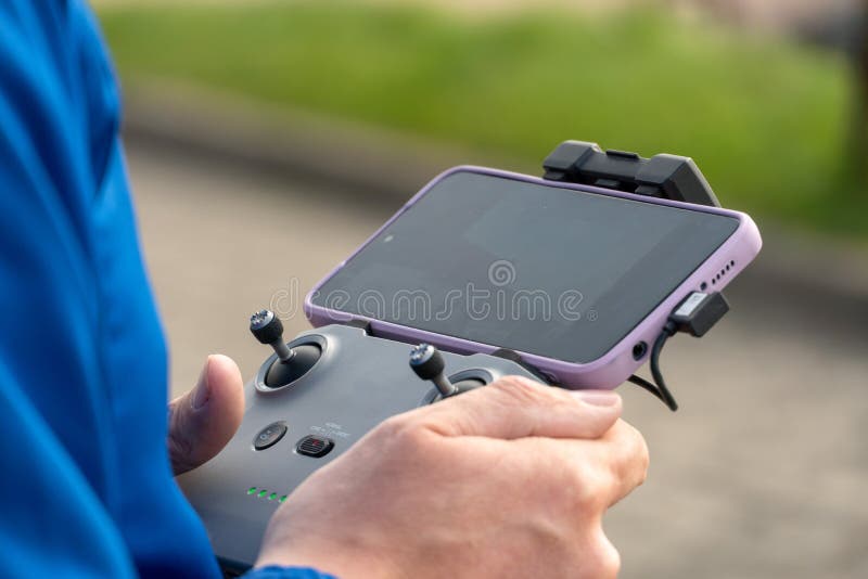 The Operator Holds the Remote Control of the Drone in His Hands. a ...