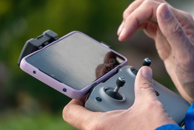 The Operator Holds the Remote Control of the Drone in His Hands. a ...