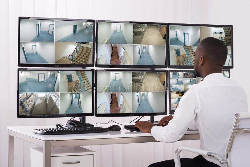 Sad Male Operator Looking at Graphs on Multiple Computer Screen Stock ...