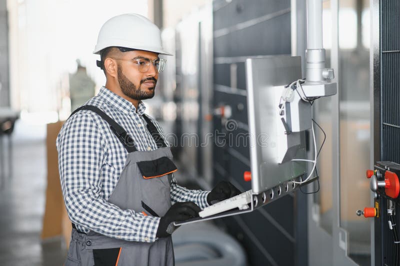 Operator of Machine. Industrial Worker Indoors in Factory Stock Photo ...