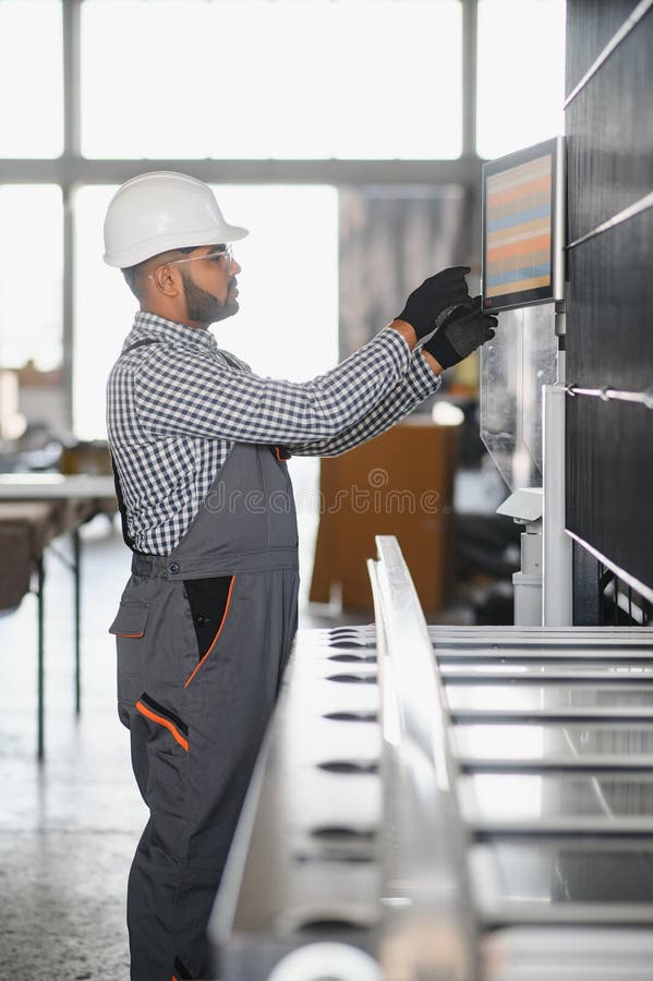 Operator of Machine. Industrial Worker Indoors in Factory Stock Photo ...