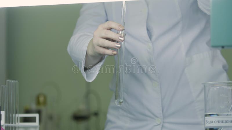 The Operator Measuring a Sample of Water or Solution in a Chemical ...