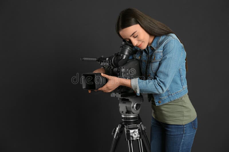 Operator with Professional Video Camera on Black Background Stock Photo ...