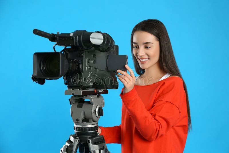 Operator with Professional Video Camera on Blue Background Stock Photo ...