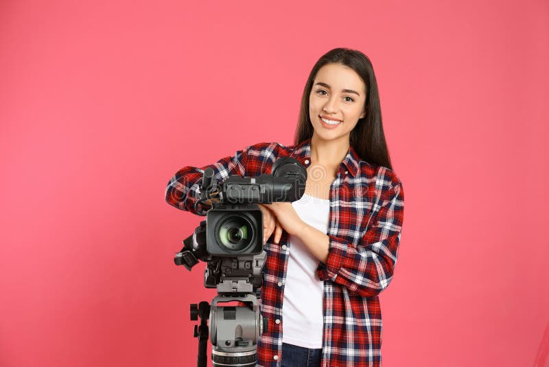 Operator with Professional Video Camera on Pink Background Stock Image ...