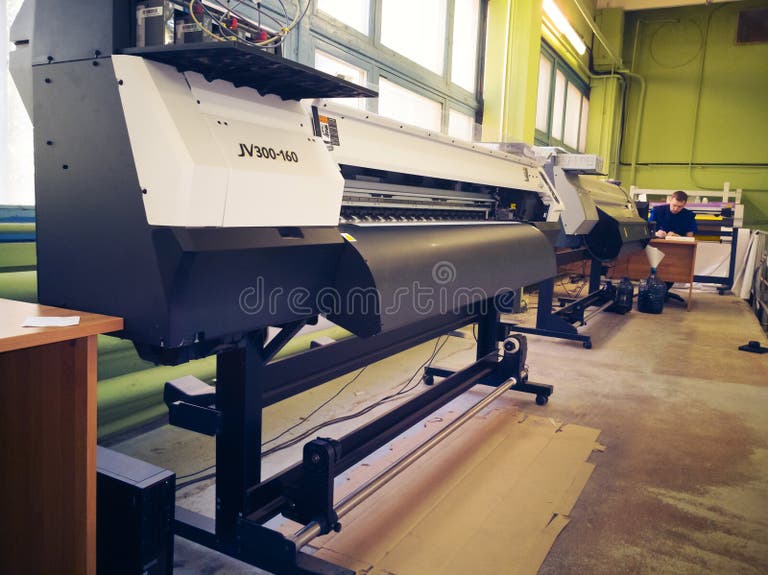 Operator of Professional Wide Format Printier Makes a Report after Work ...